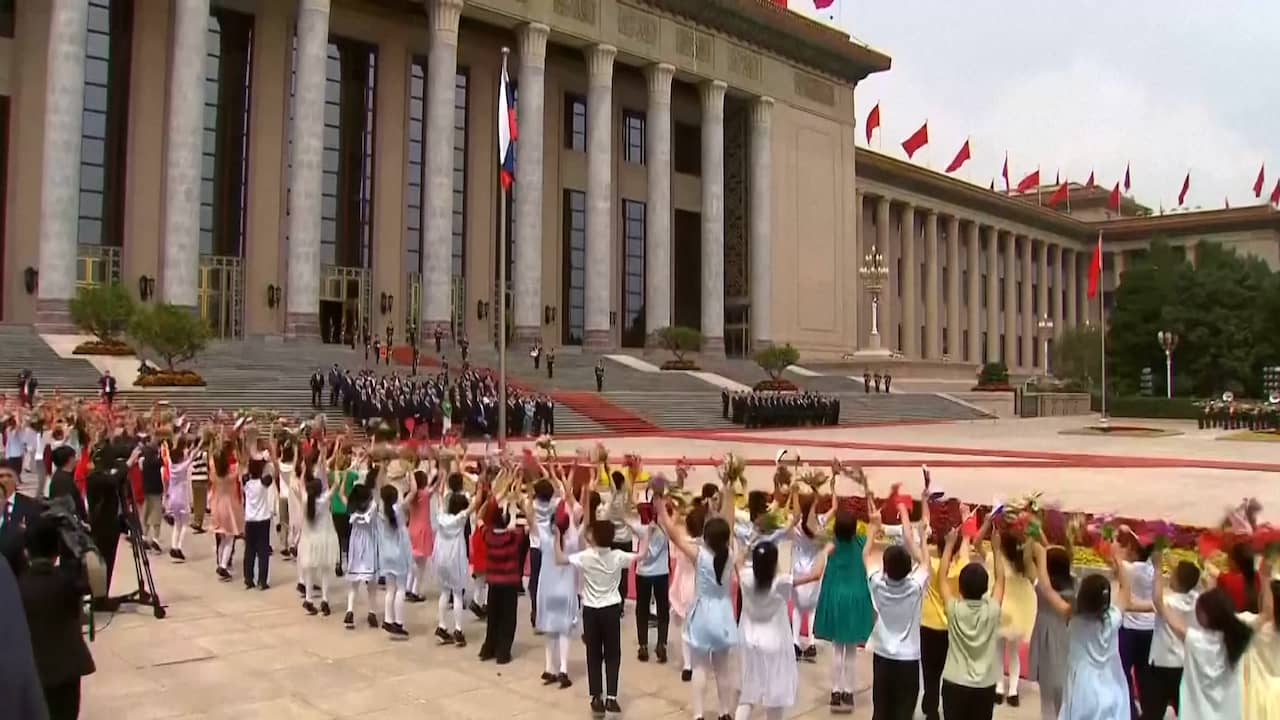 Chinese jongeren ontvangen Poetin al springend met vlaggetjes | NU.nl