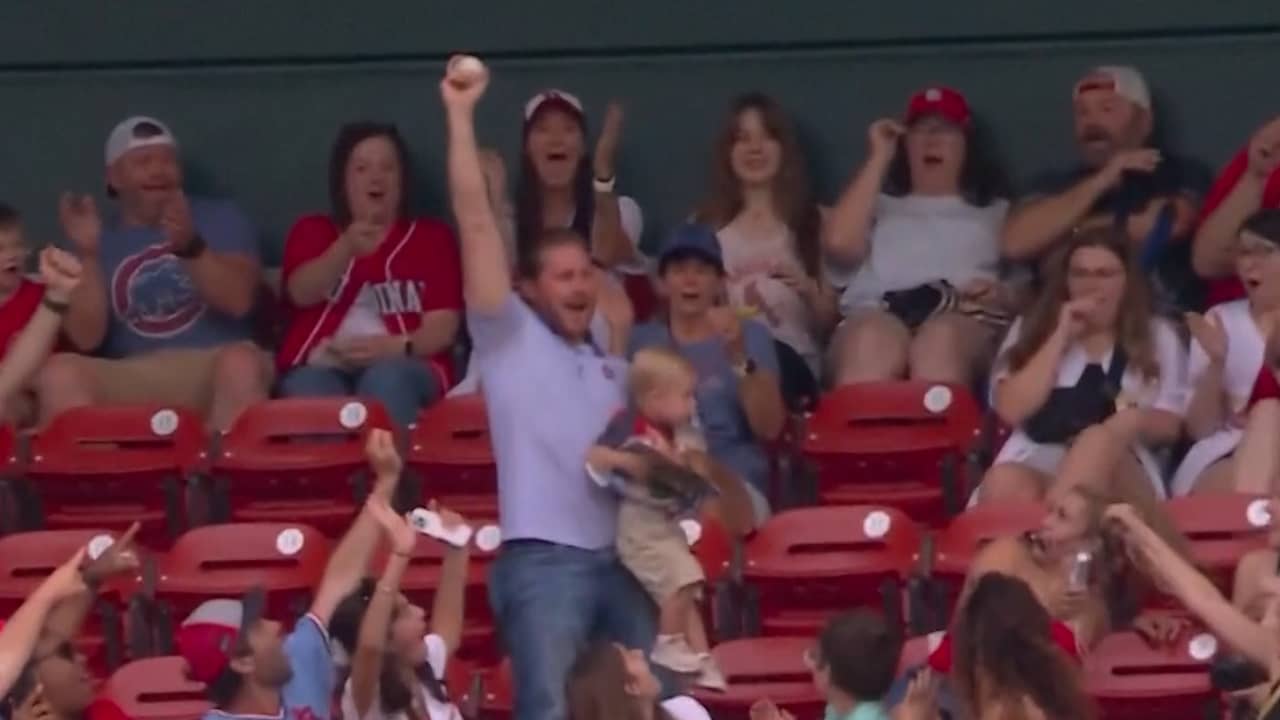 Amerikaanse fan met peuter op arm vangt op knappe wijze honkbal | NU.nl